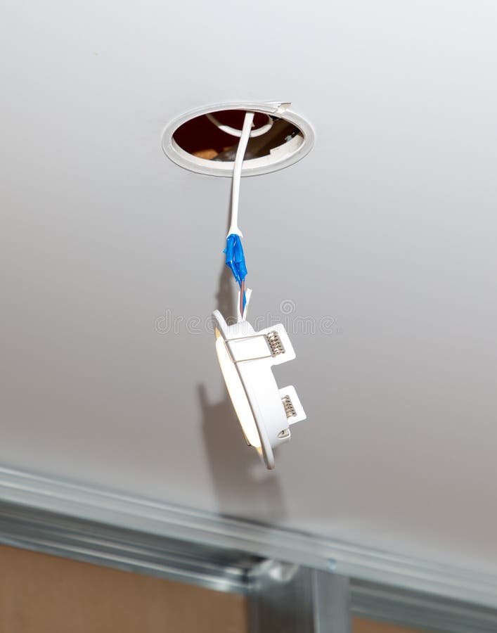 Torn Stretch Ceiling Near the Light Bulb Stock Image - Image of stretch ...