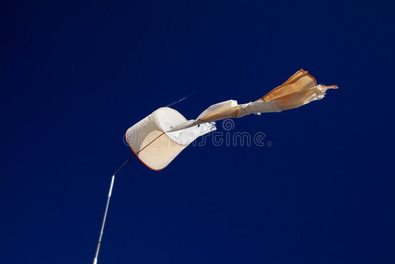 Torn Windsock Against Dark Blue Sky Stock Photo - Image of change ...
