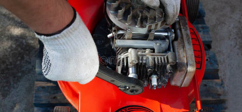 Repairman Fixes the Lawn Mower Engine with Tools at the Workshop Stock ...
