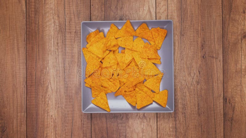 Tortilla Chips Filling a Rotating Rectangular Plate - Stop Motion Stock ...