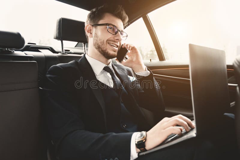 Young Businessman Talking on Phone in Car Using Pc Stock Photo - Image ...