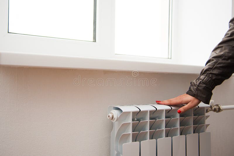 Touching the radiator stock photo. Image of heater, interior - 82541028