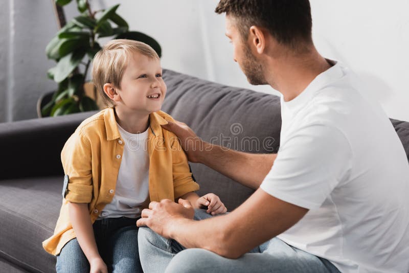 Touching Shoulder of Smiling Son while Stock Photo - Image of home ...
