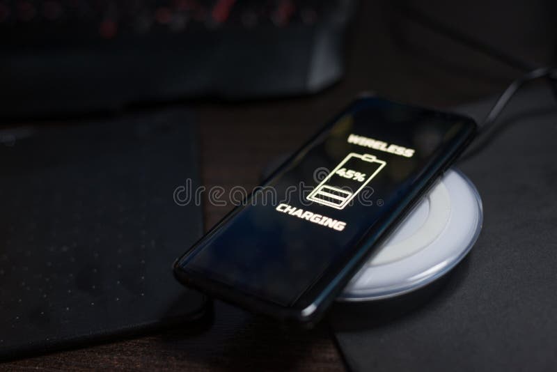 Touchscreen Smartphone Wireless Charging on Induction Charger. Stock ...