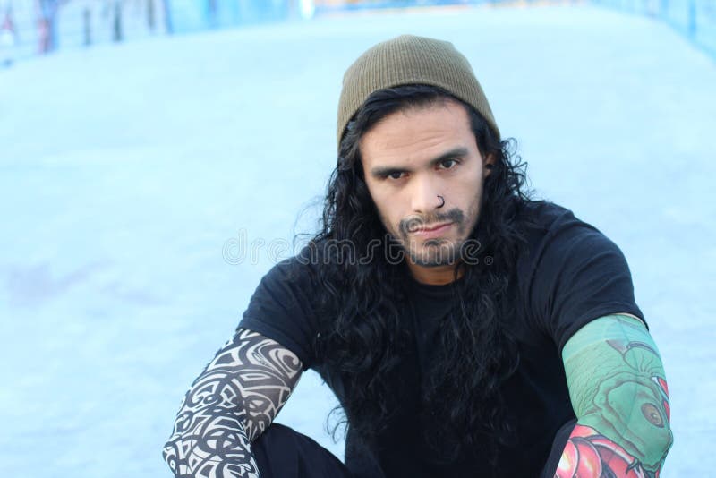 Tough Looking Hispanic Man with Long Hair and Tattoos Stock Image ...