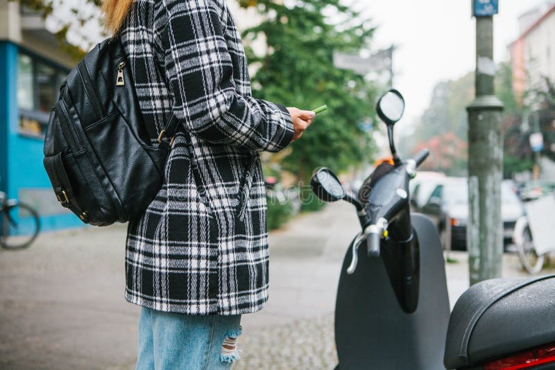 A Tourist with a Backpack is Going To Use an Electric Scooter through a ...