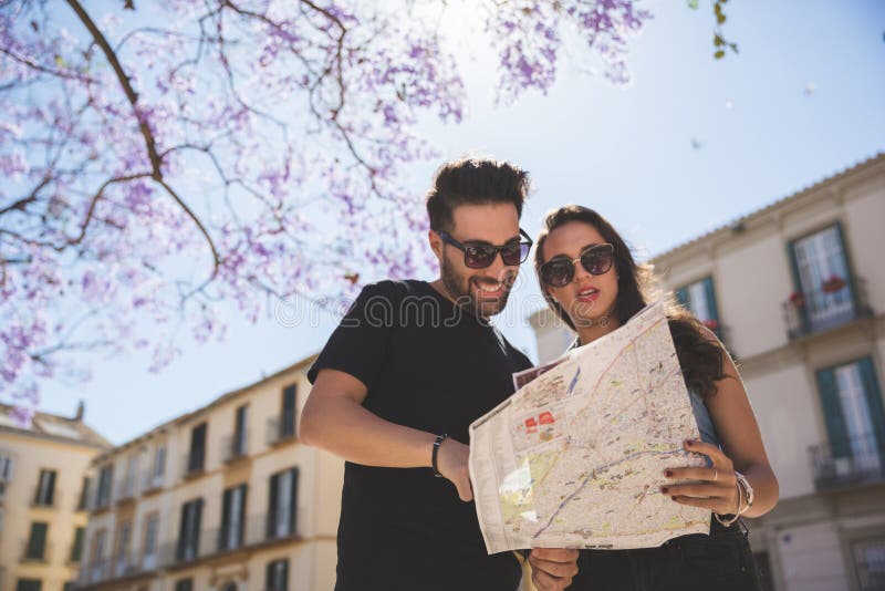 Tourist Couple Looking at Map Standing Outside Stock Image - Image of ...