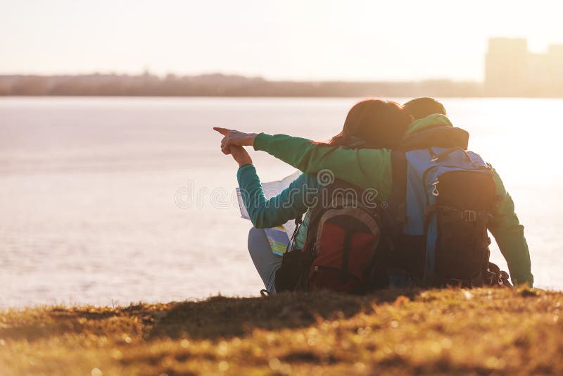 Tourist Couple Looking at Water Stock Photo - Image of grass, relax ...