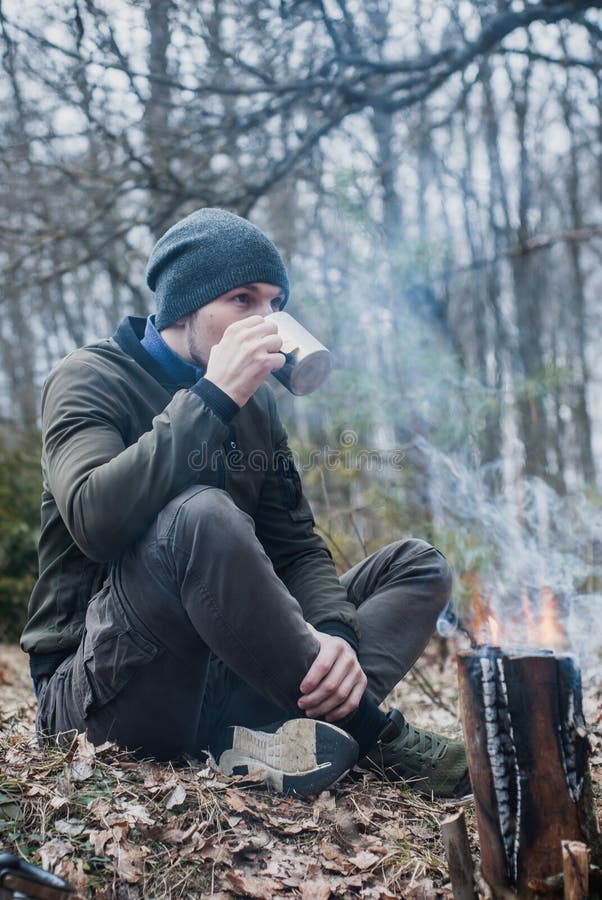 A Tourist Drinks Tea in the Forest by the Fire, the Concept of Hiking ...