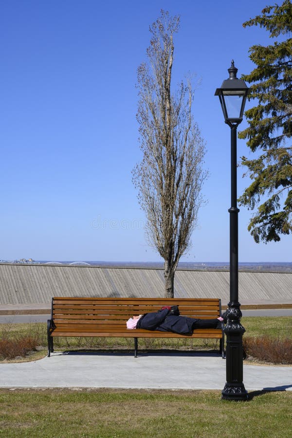 A Tourist on a Bench Under a Lantern in Early Spring Stock Image ...