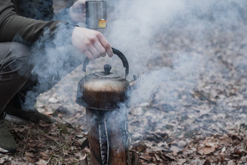 A Tourist Makes Tea in the Forest, an Old Teapot on a Fire, Stock Image ...