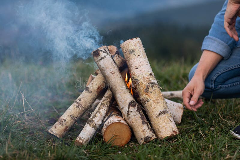 A Tourist is Making Camp Fire in the Mountains in the Evening. Burning ...