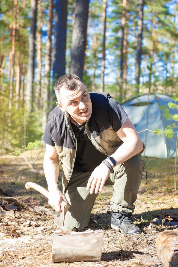Tourist Man Chops Tree in Forest with Sharp Ax Stock Photo - Image of tent, male: 317154856