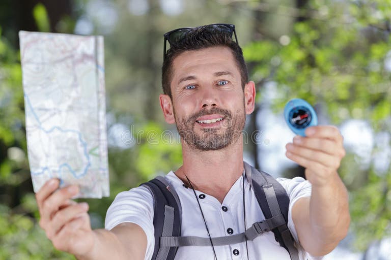 Tourist Man in Forest with Compass and Map Stock Photo - Image of ...