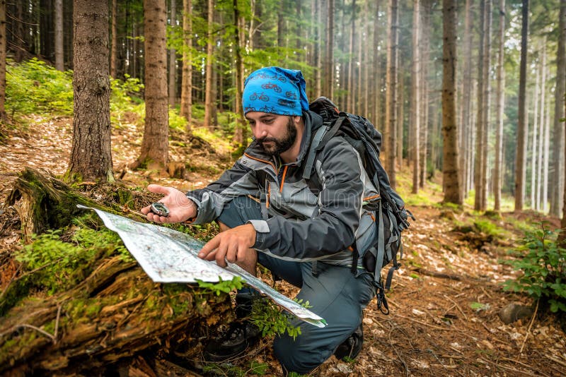 Tourist Man with Map and Compass in the Wilderness Stock Photo - Image ...