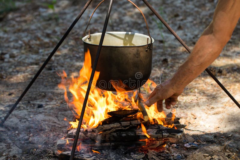 Tourist Pot Hanging Over the Fire on a Tripod. Cooking in the Ca Stock ...