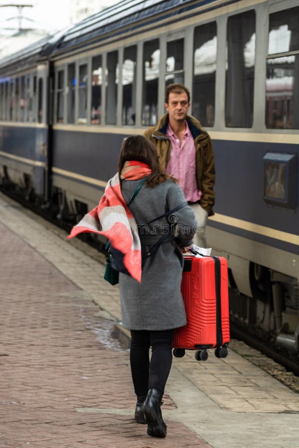 Tourist Pulling Luggage. Commuters Walking at Railroad Station Platform ...