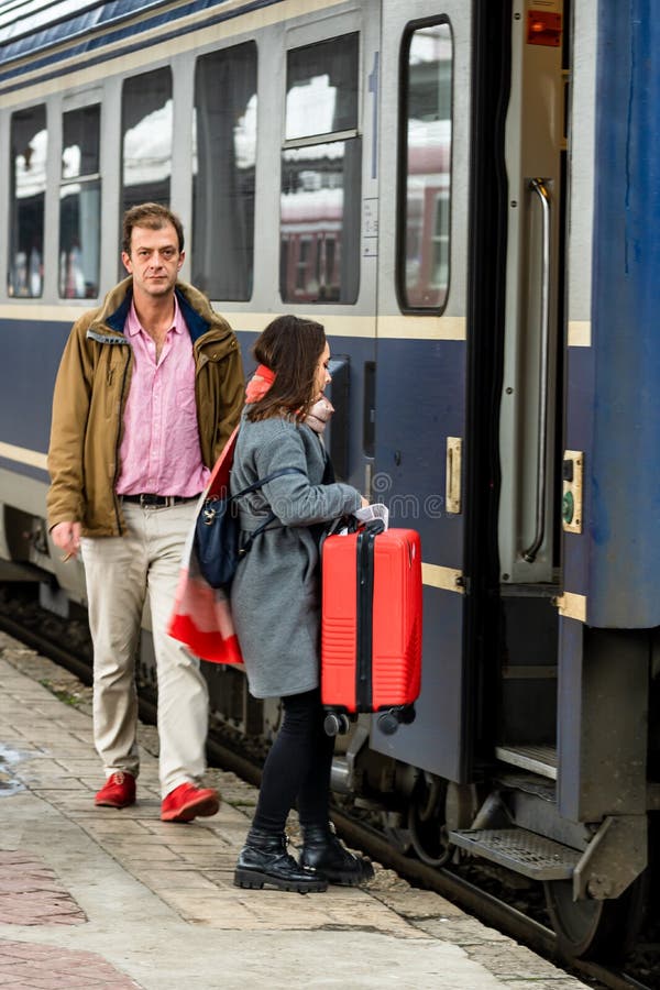 Tourist Pulling Luggage. Commuters Walking at Railroad Station Platform ...
