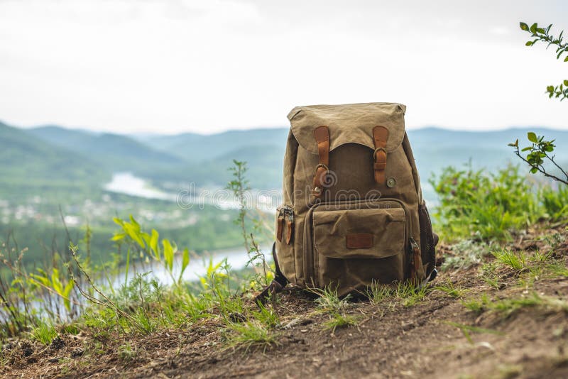 Tourist`s Brown Backpack on the Edge of a Cliff. There are River ...