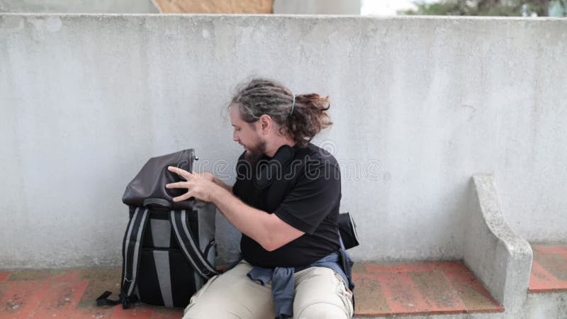 Tourist Searching Inside Backpack on Bench Stock Footage - Video of ...