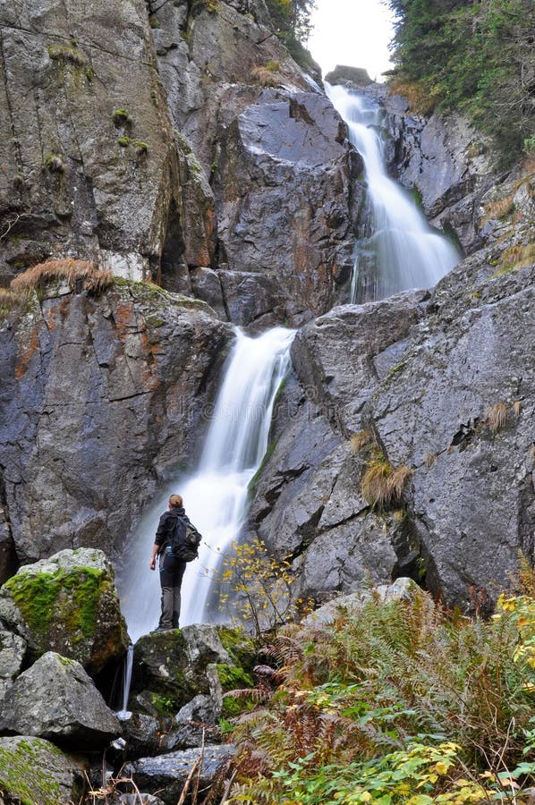 Tourist Standing in the Front of a Waterfall Stock Image - Image of ...