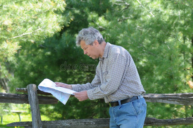 Tourist studying a map stock photo. Image of wooden, rail - 14498782