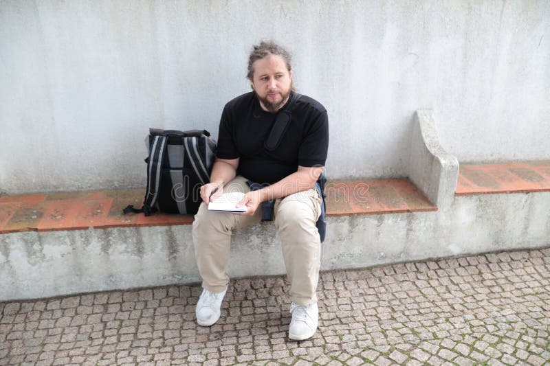 Tourist Taking Notes while Sitting on Bench Outdoors Stock Photo ...