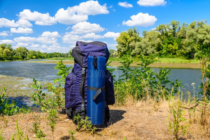 Touristic Backpack on a Bank of River Stock Photo - Image of nature ...