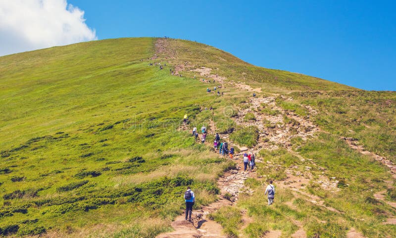 Tourists Go Up the Mountain on a Steep Rocky Path. Conquest of the ...