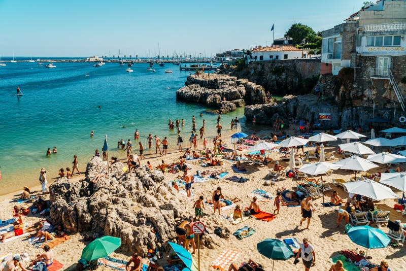 Tourists Having Fun in Water, Relaxing and Sunbathing in Cascais Ocean ... Tourists Having Fun in Water, Relaxing and Sunbathing in Cascais Ocean ...
