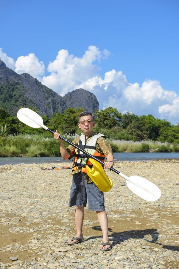 Tourists holding an oar stock photo. Image of helmet - 47740810