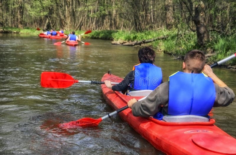 Tourists kayaking on river editorial stock photo. Image of activity ...
