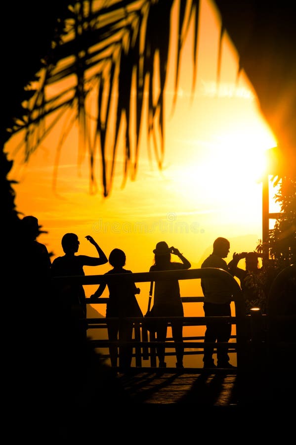 Tourists in Tropical Sunset Stock Photo - Image of beautiful, orange ...