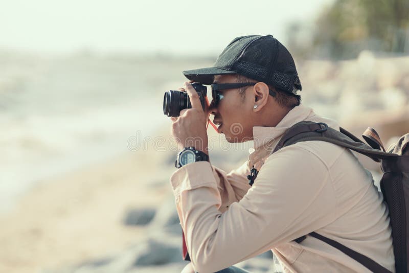 Tourists Use Camera To Shoot Sunset on the Beach. Backpacker and Travel ...
