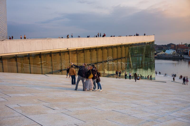 Tourists View a Sunset from the Oslo Opera House, Which Was Built in ... Tourists View a Sunset from the Oslo Opera House, Which Was Built in ...
