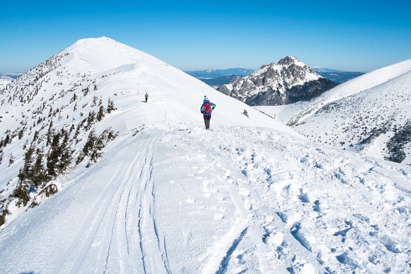 Tourists Walking Along the Ridge of Snowy Mountains Stock Photo - Image ...
