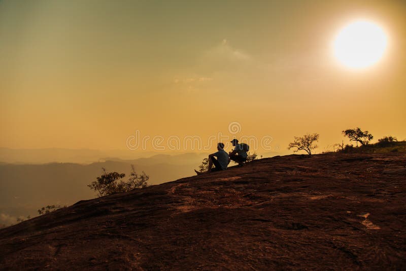 Tourists Watching the Sunset on Top of the Mountain. Stock Photo ...