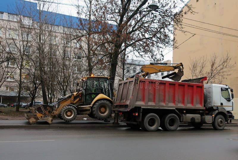Towed Tractor Loading a Truck Stock Photo - Image of cabin, bucket ...