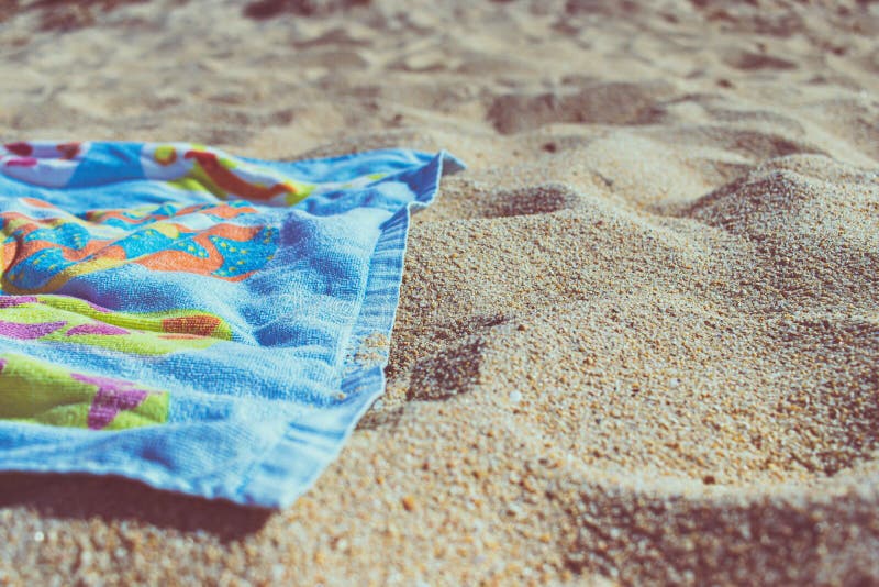 Towel on the beach sand stock photo. Image of holiday - 186223430