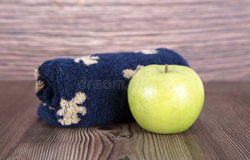 Towel and a green apple stock image. Image of habit - 229211513