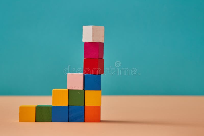 Tower Built of Colored Cubes with White Block on Top. Empty Copy Space ...