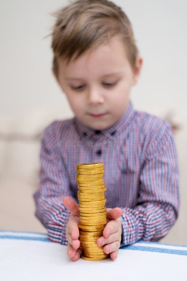 Tower of Coins. a Little Boy Builds a Column of Gold Coins Stock Image ...