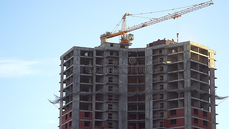 Tower Construction Crane and Construction Workers are Building a Tall ...