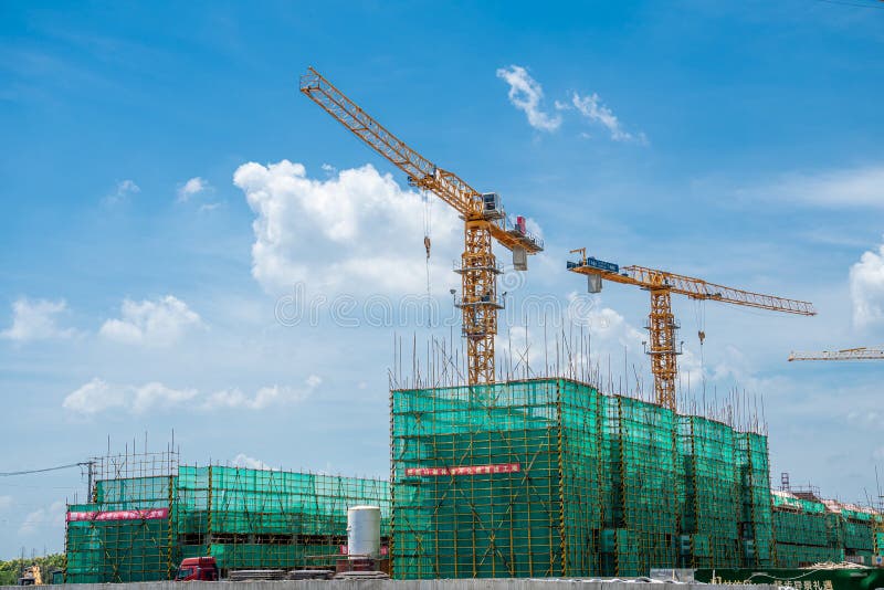 The Tower Crane on the Construction Site is Building a High-rise ...