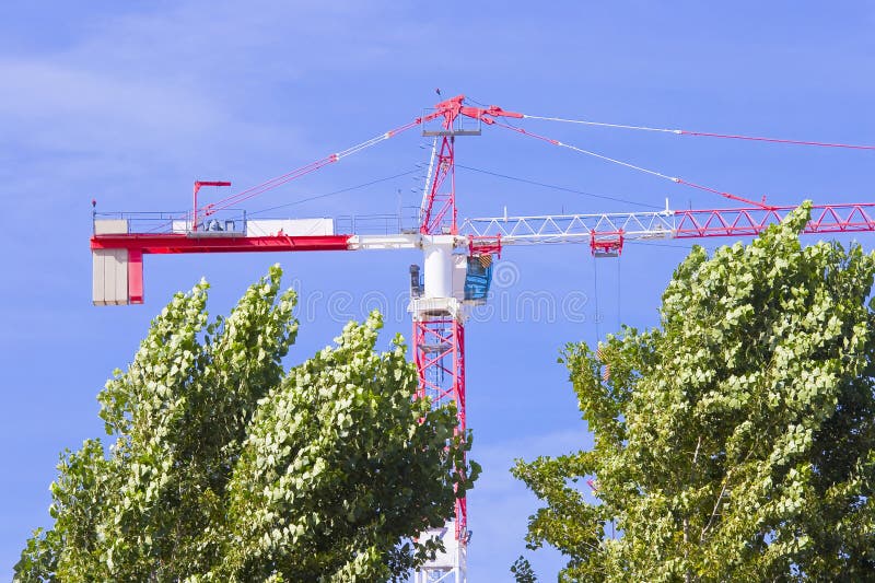 TOWER CRANE in a CONSTRUCTION SITE with Trees and Blue Sky Stock Photo ...
