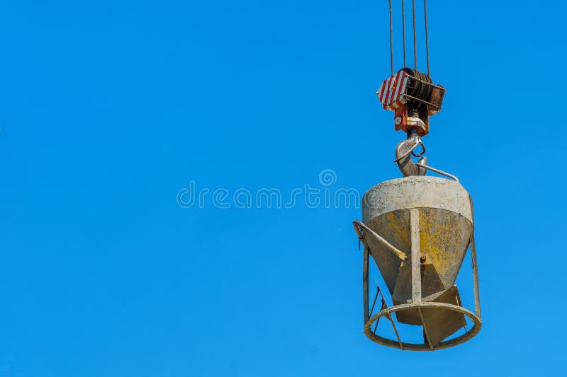 Tower Crane Lifting a Concrete Bucket for Pour of Concrete Cement Mix ...
