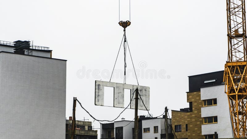 Tower Crane Lifts a Monolithic Block Against the Backdrop of a ...