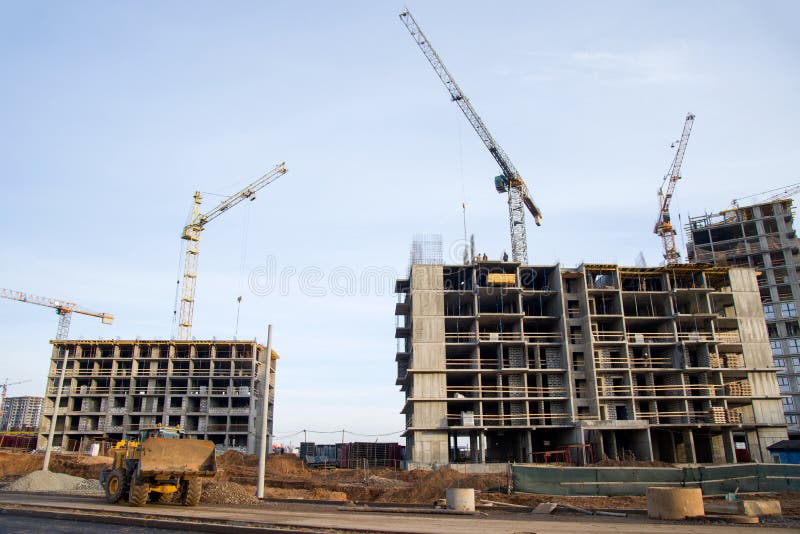 Tower Cranes Constructing a New Residential Build. Pouring Concrete ...