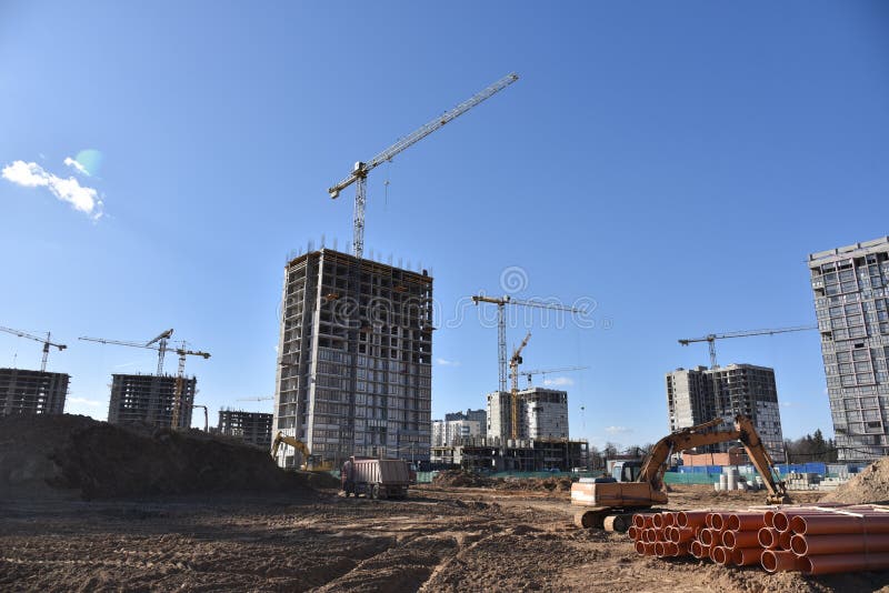 Tower Cranes Constructing Residential Buildings. Excavator on ...