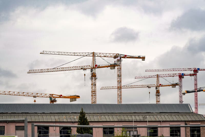 Tower Cranes at the Construction Site for Lifting Loads. Stock Image ...